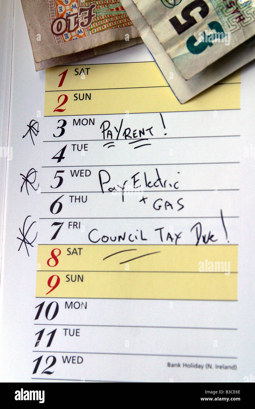 calendar marked with dates of bills to be paid with some british pound ...