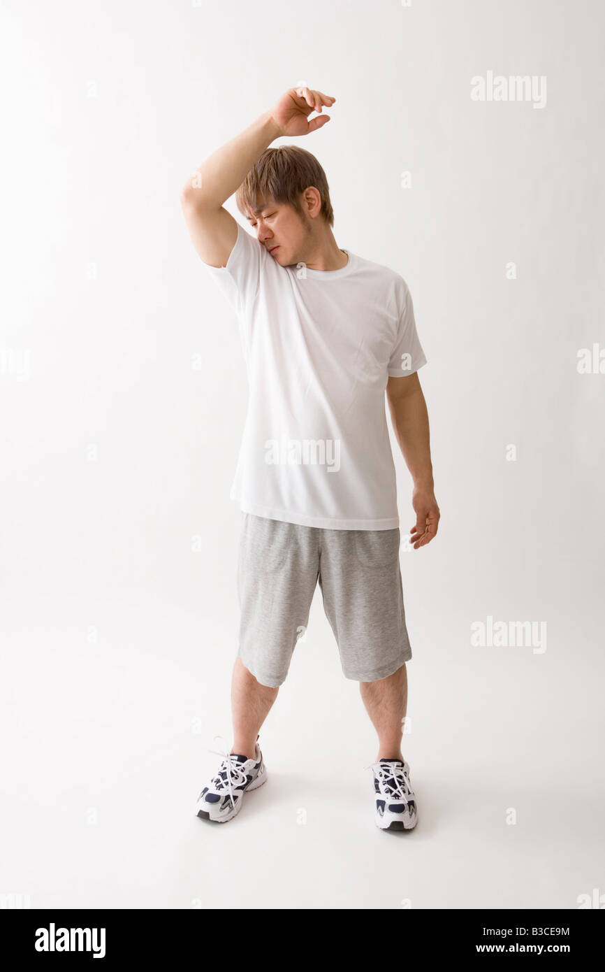 Mid adult man sniffing his underarm Stock Photo - Alamy