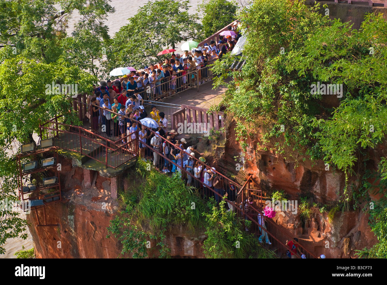 People descending Nine Turns Staircase cliff face steps viewing the ...