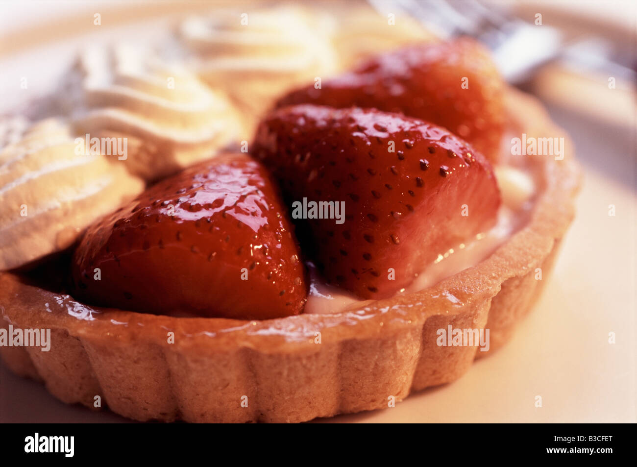 a strawberry tart with fresh piped cream Stock Photo - Alamy