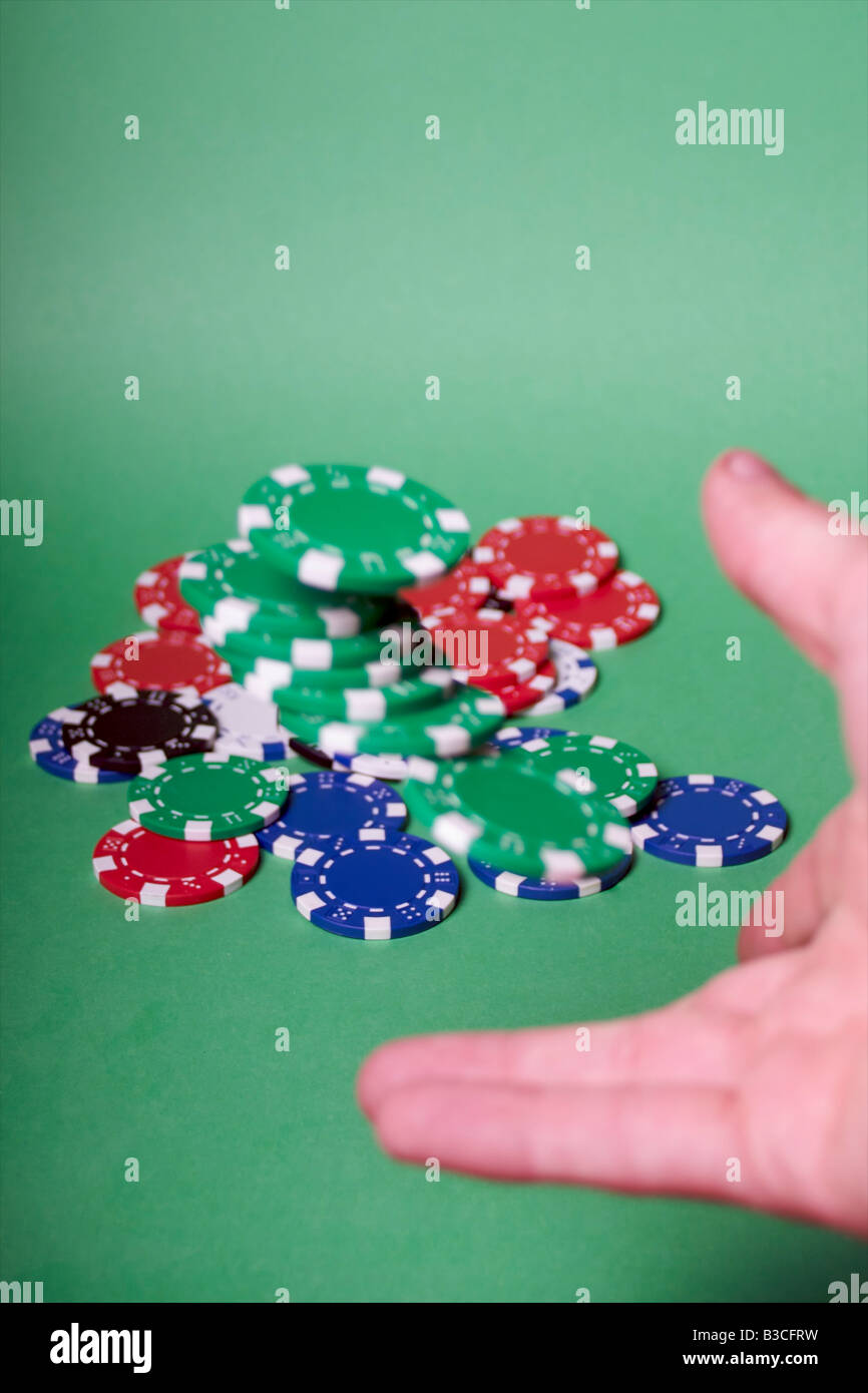 Poker chips being thrown onto a pile Stock Photo - Alamy