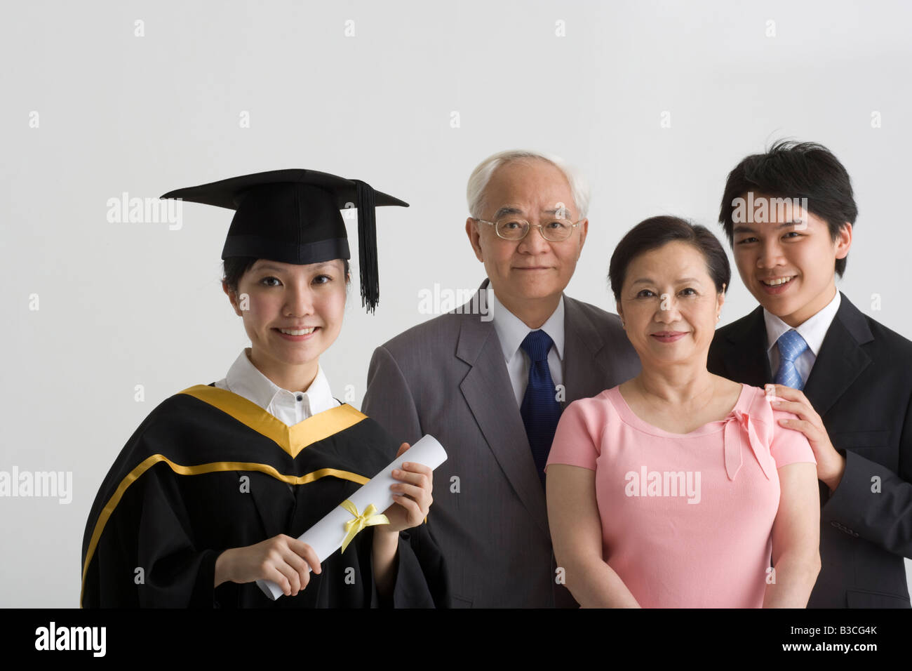 Parents Standing With Their Graduate Son High Resolution Stock ...