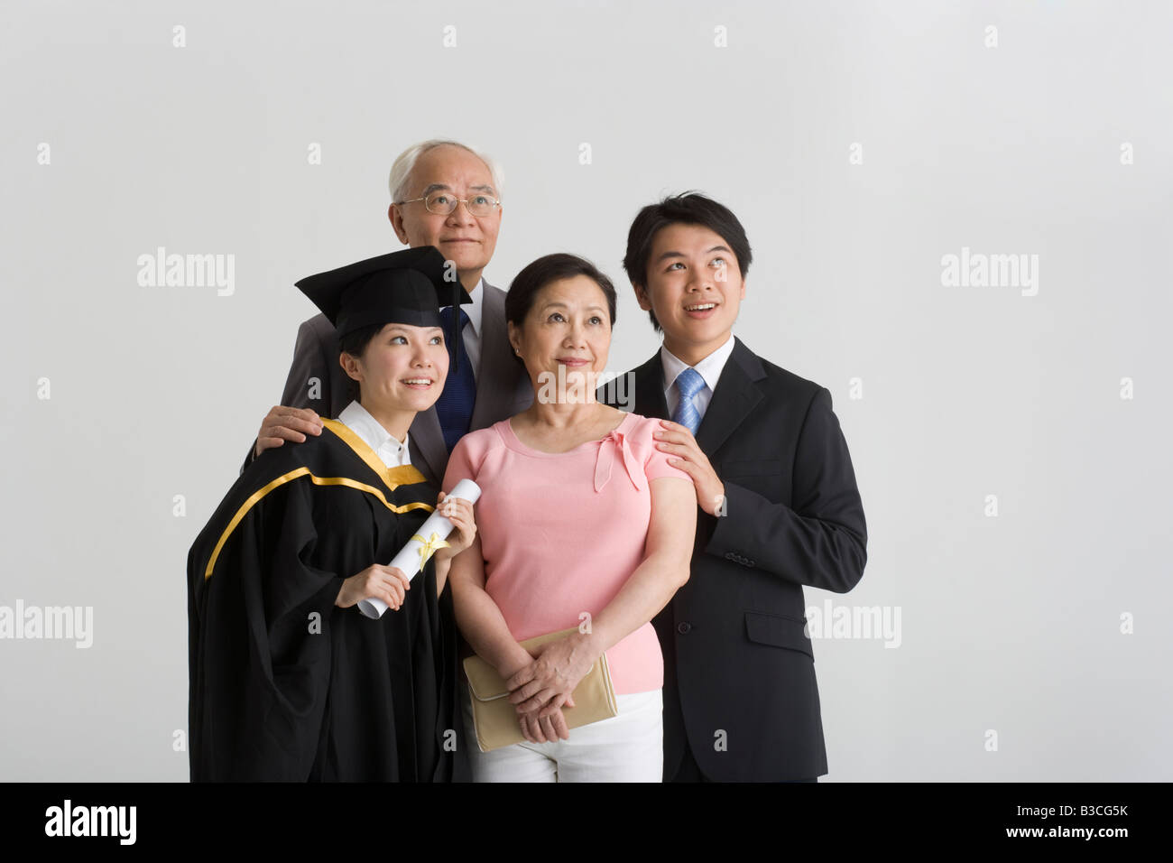 Parents Standing With Their Graduate Son High Resolution Stock ...