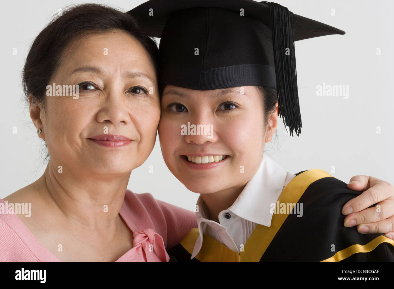 Portrait of a young female graduate smiling with her mother Stock Photo ...