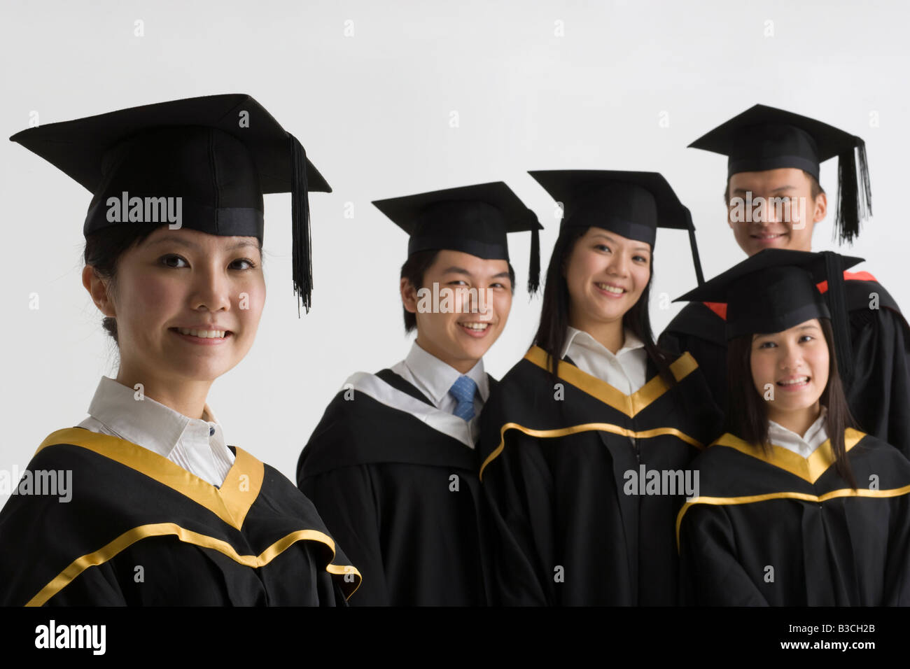 Portrait of a female graduate students smiling with her friends smiling ...
