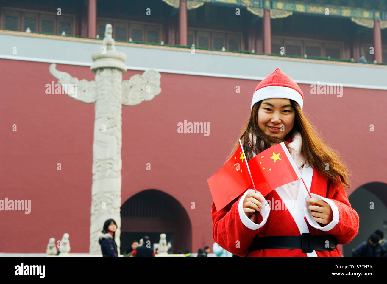 China, Beijing, Tiananmen Square. A Chinese girl dressed up as Santa on ...