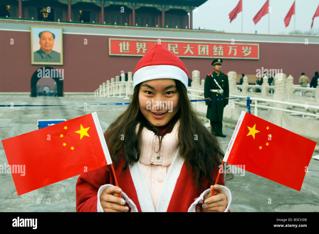 China, Beijing, Tiananmen Square. A Chinese girl dressed up as Santa on ...