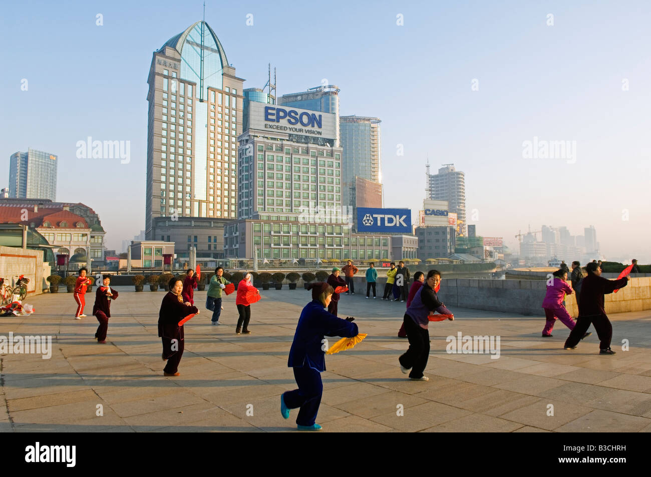China, Shanghai. Tai-chi performers in front of modern buildings Stock ...