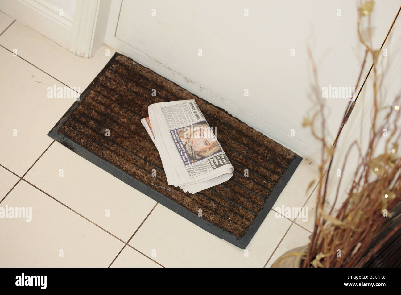 Newspaper on Doormat Stock Photo - Alamy