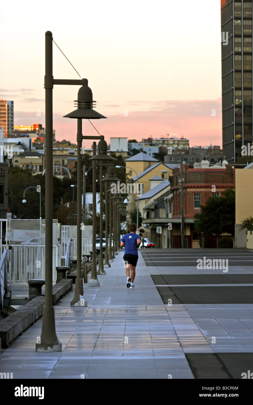 Early morning jogger on a run in the city Stock Photo - Alamy