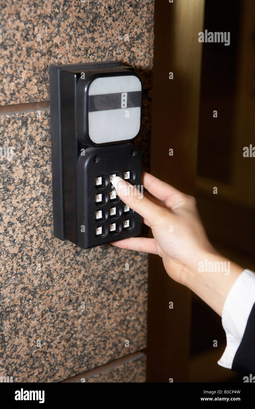 Hand of young businesswoman entering access code Stock Photo - Alamy