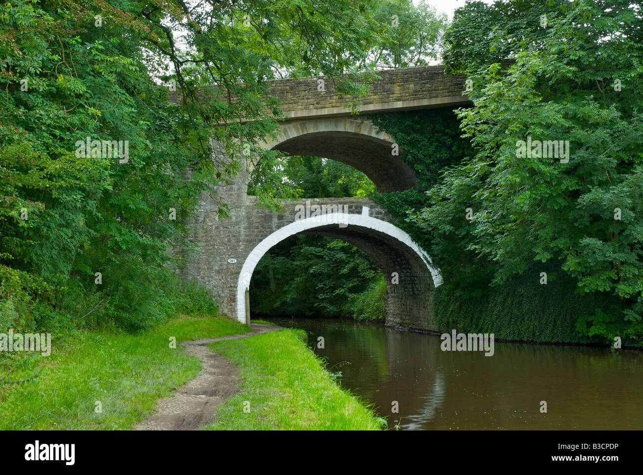 Double-arched bridge carrying A59 road over Leeds-Liverpool Canal at ...