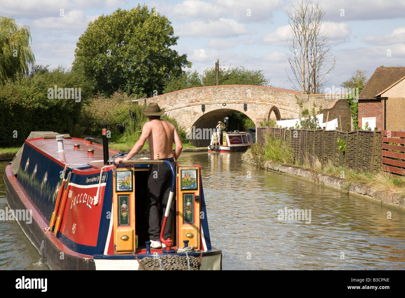 narrowboats going under a bridge on the Grand Union Canal near Tring in ...