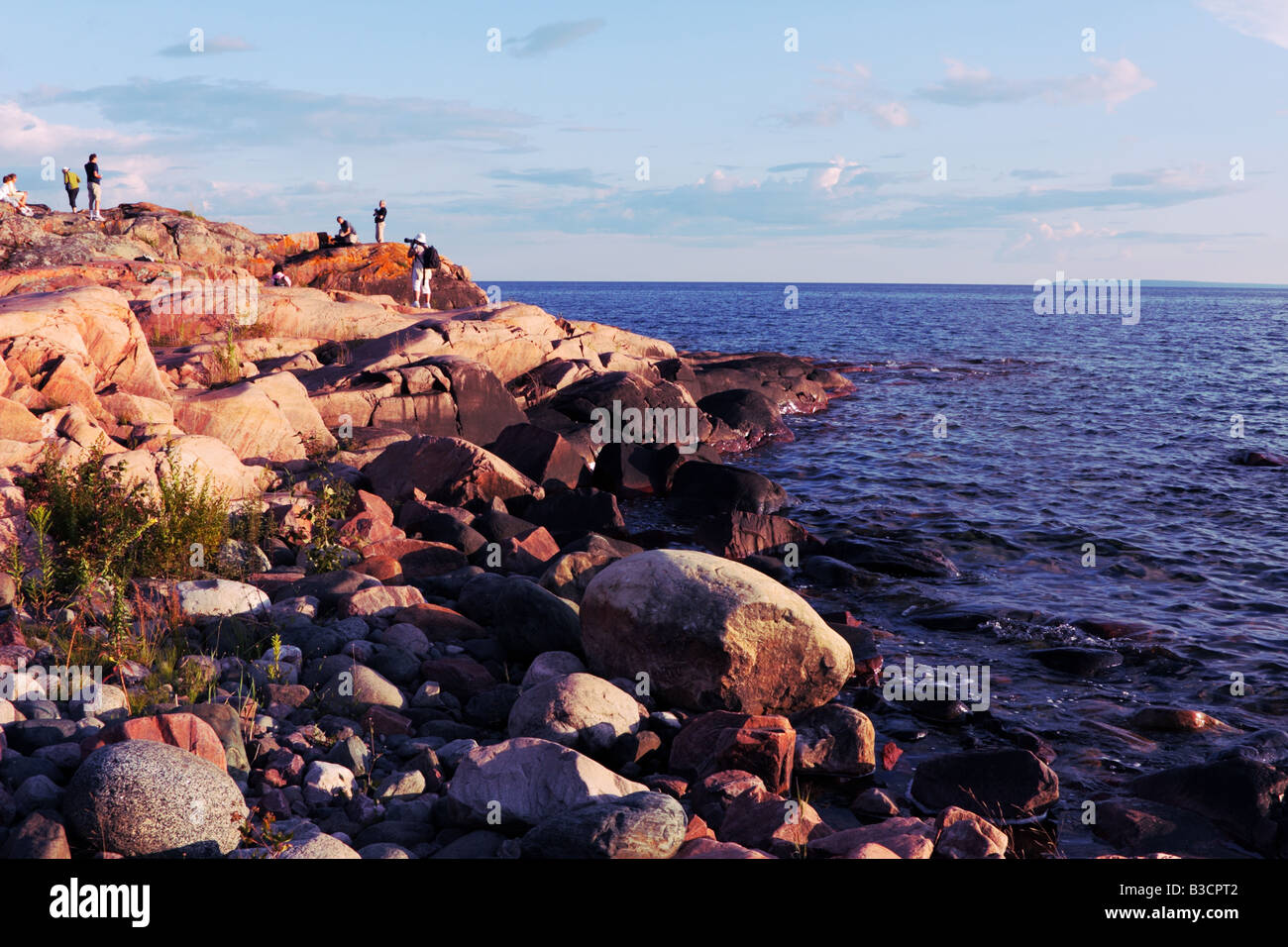 Tourists and photographers on Red Rock Point Georgian Bay at sunset ...