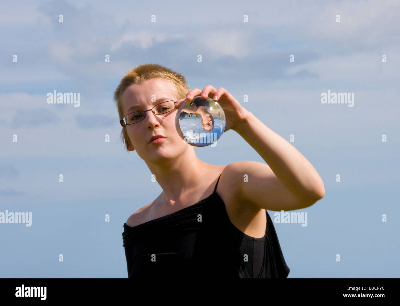 girl and reflection in glass ball Stock Photo - Alamy