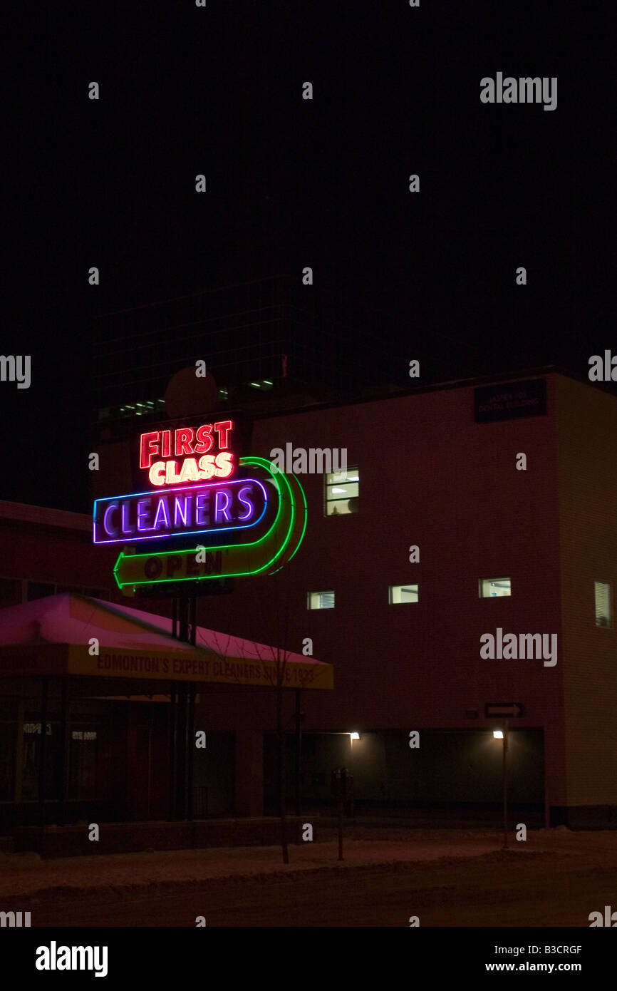A neon sign advertising a dry cleaning store Stock Photo - Alamy
