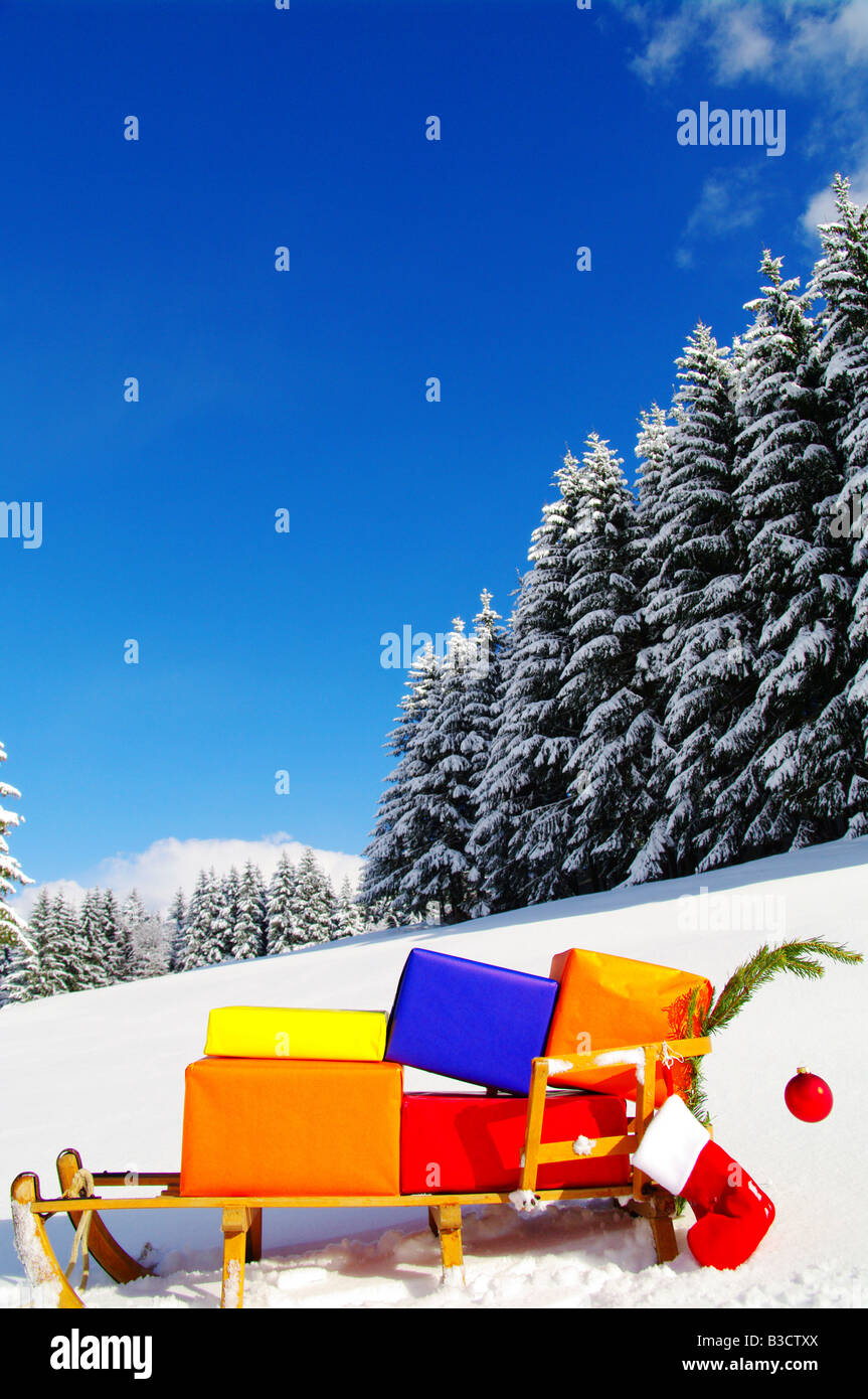 colorful presents on a sledge in a winter landscape Stock Photo - Alamy