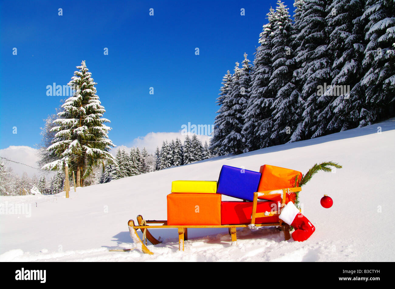 colorful presents on a sledge in a winter landscape Stock Photo - Alamy