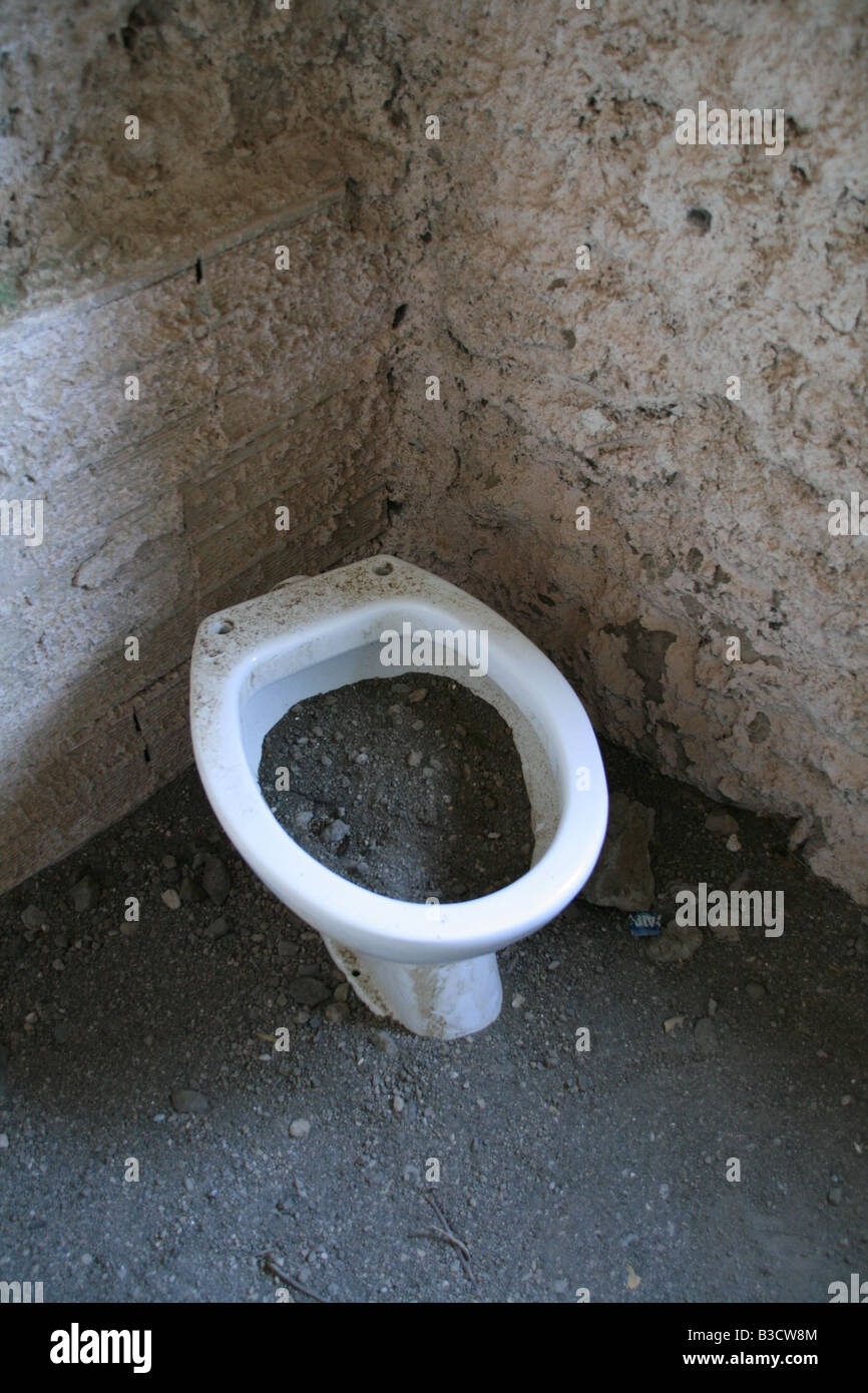 old damaged toilet pan inside derelict building Stock Photo - Alamy