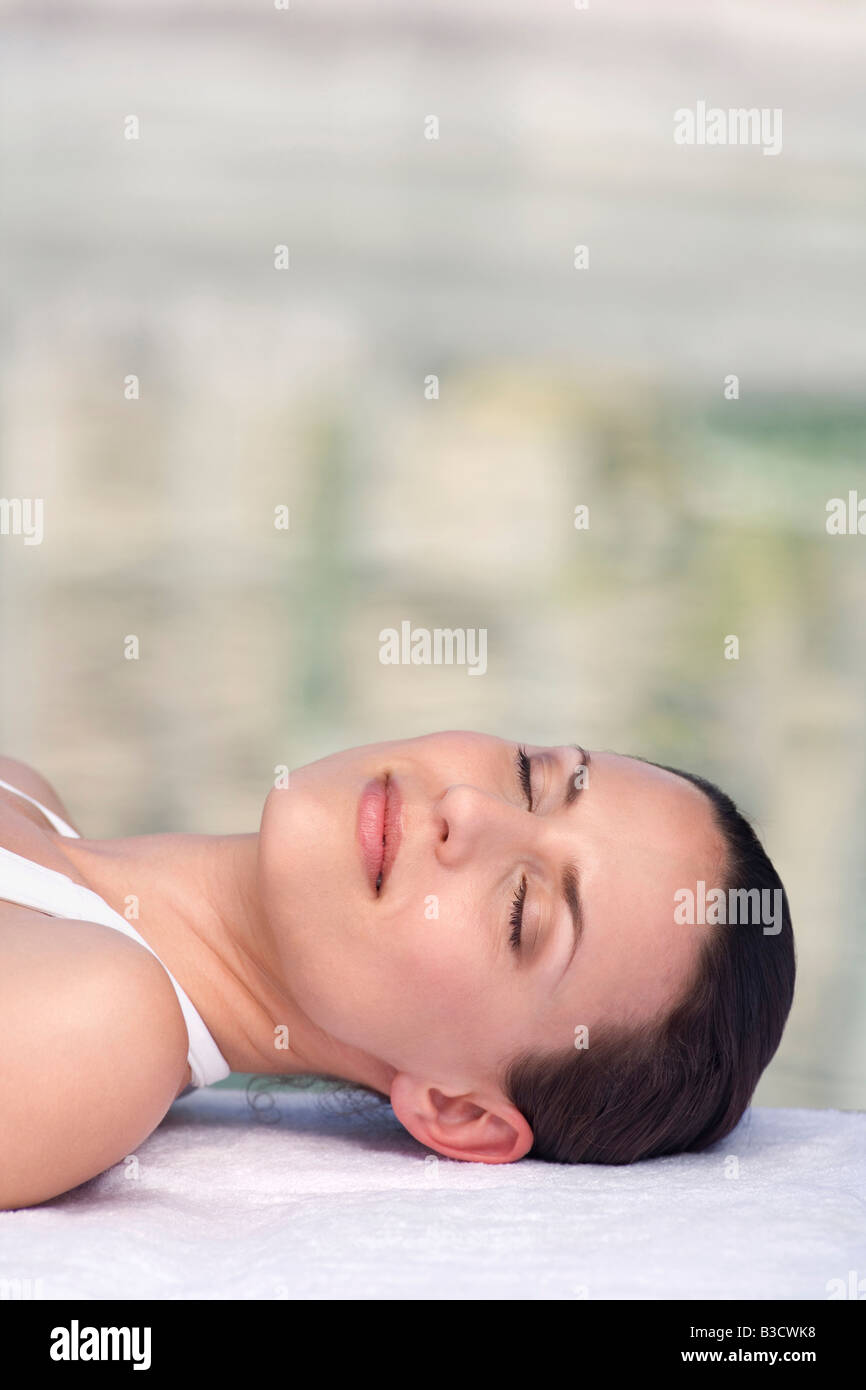 Young woman relaxing on pool side, portrait Stock Photo - Alamy