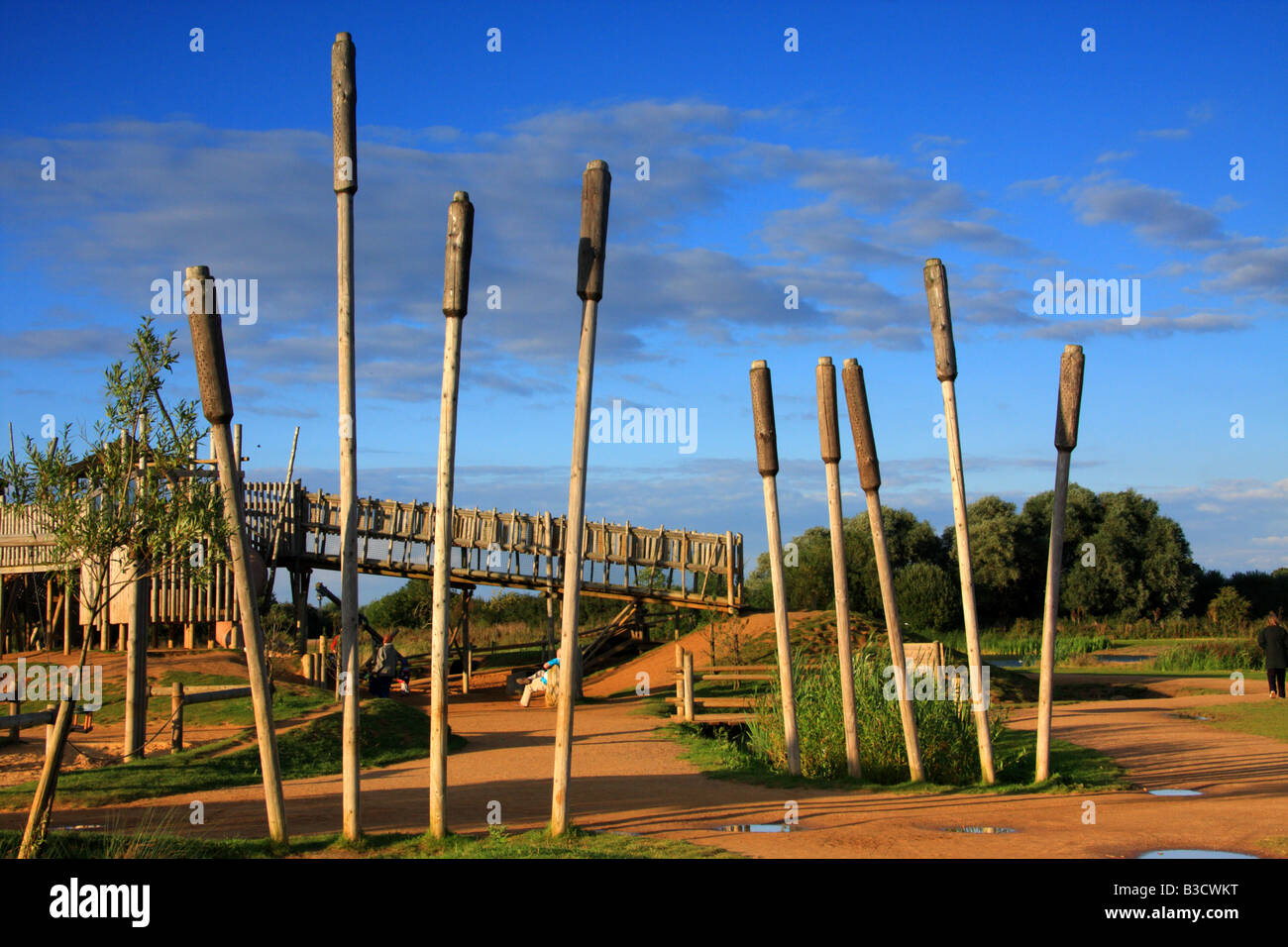 Giant wooden bullrushes stand against a blue sky at the entrance to an ...
