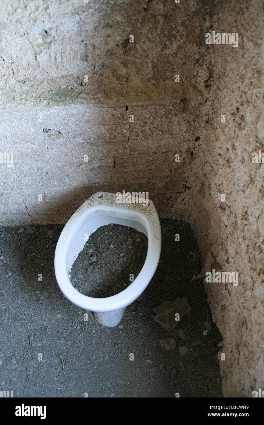 old damaged toilet pan inside derelict building Stock Photo - Alamy