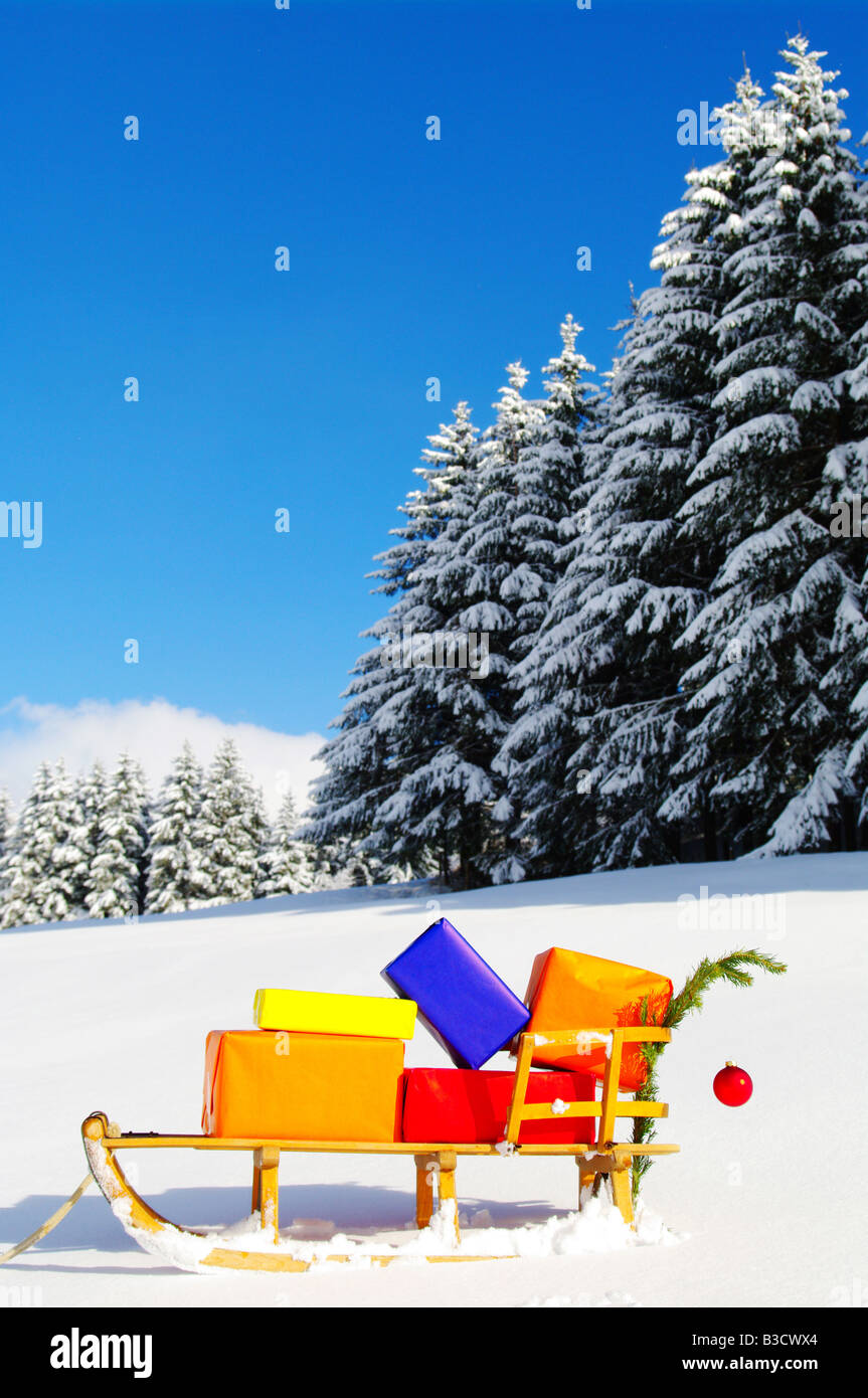 colorful presents on a sledge in a winter landscape Stock Photo - Alamy