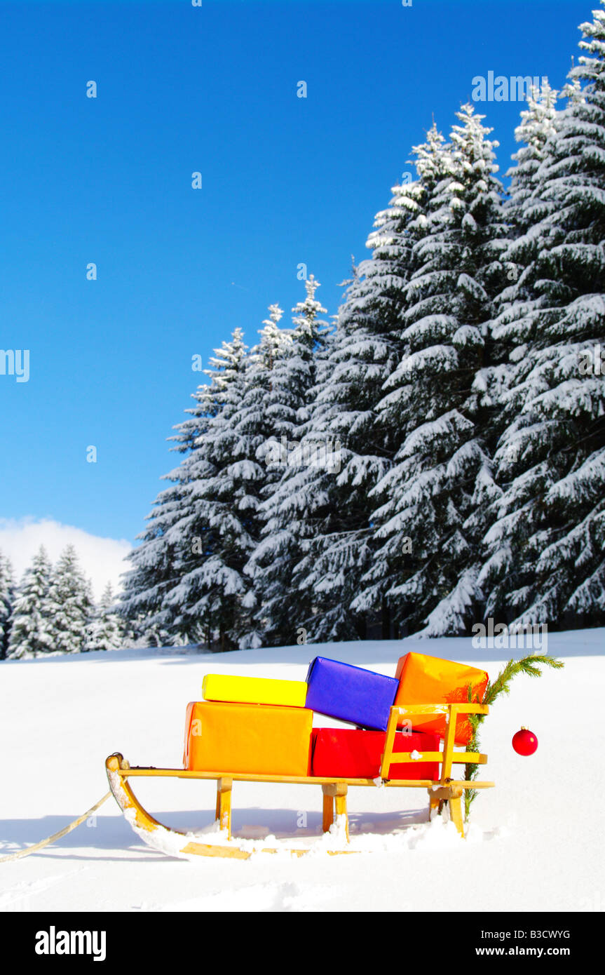 colorful presents on a sledge in a winter landscape Stock Photo - Alamy