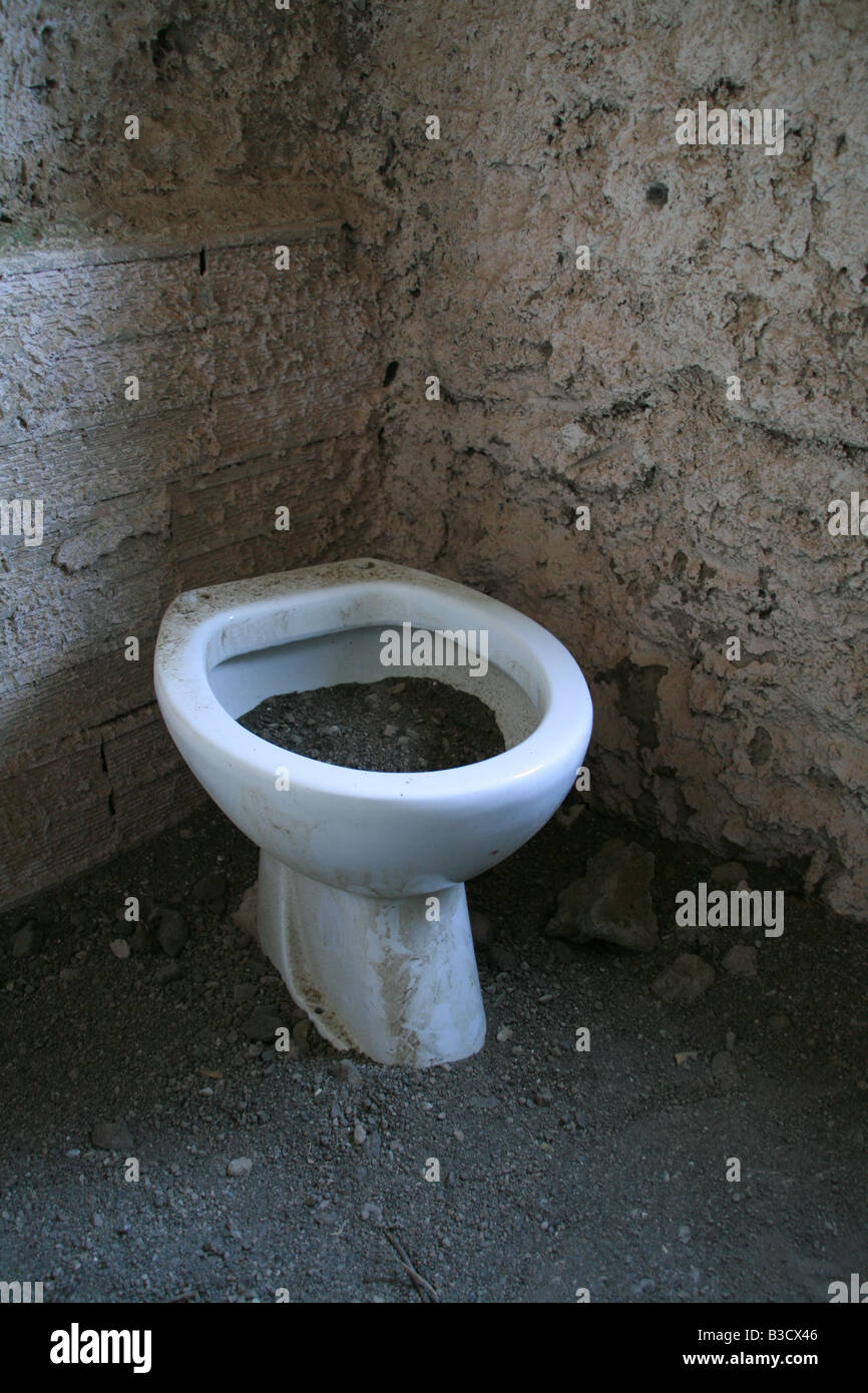 old damaged toilet pan inside derelict building Stock Photo - Alamy