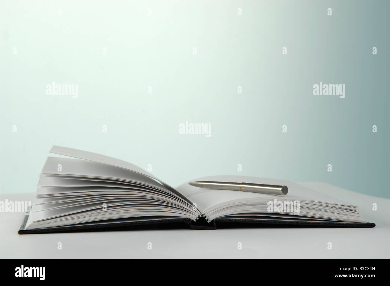 Notebook with pen Stock Photo - Alamy