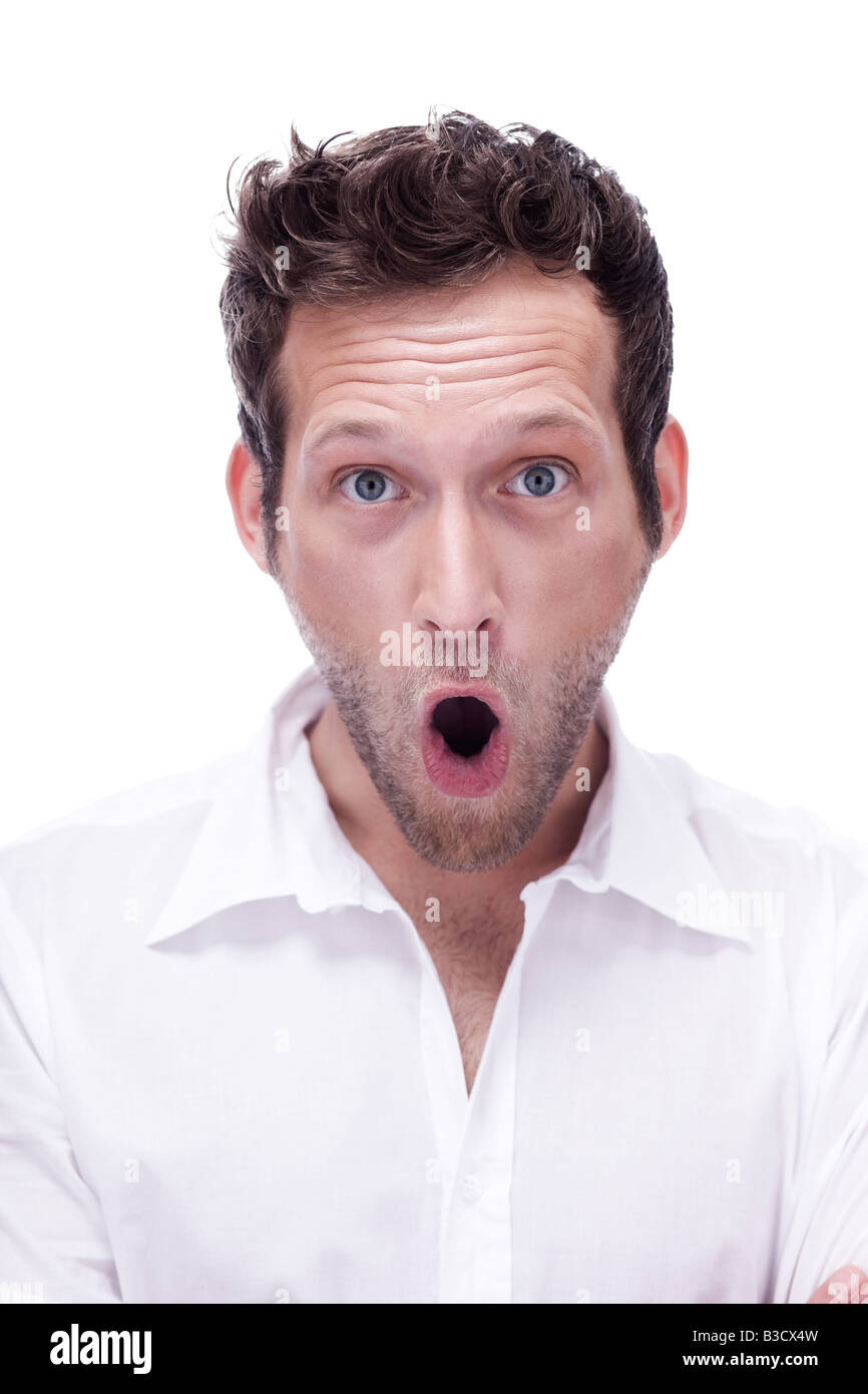 Portrait of a young man looking surprised Stock Photo - Alamy