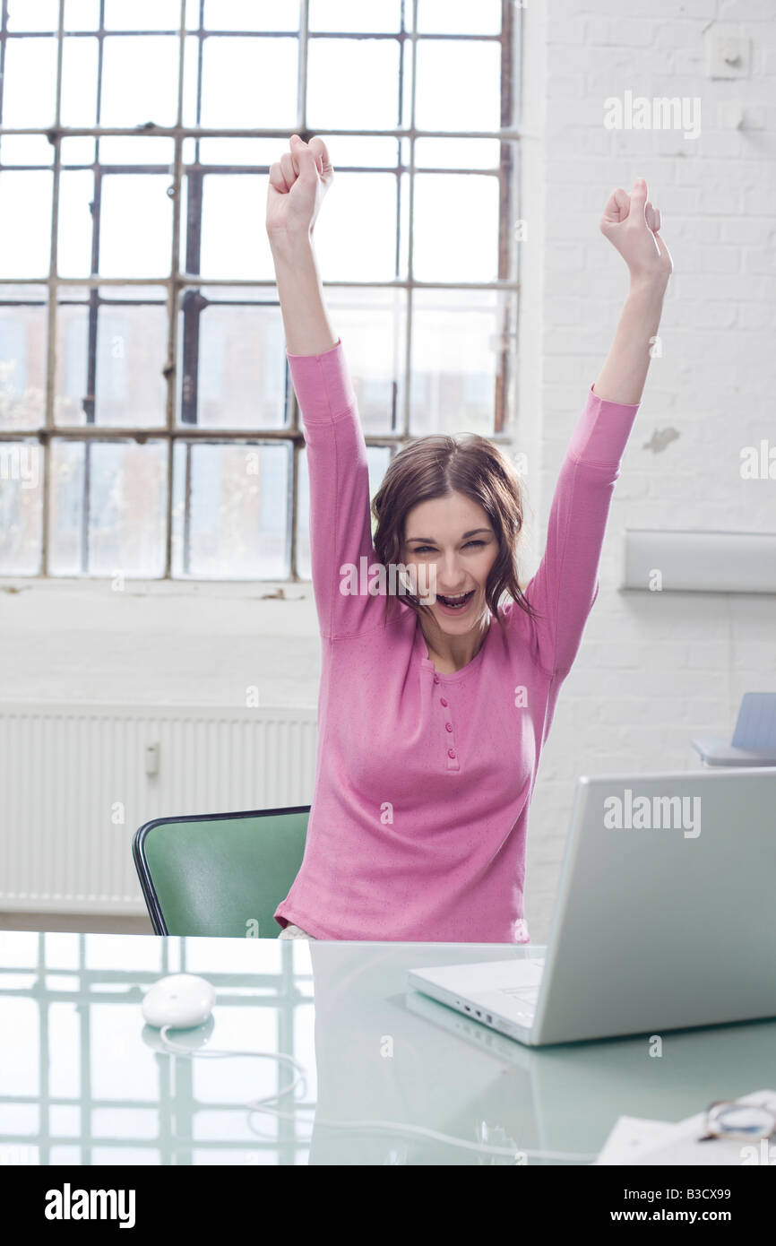 Young businesswoman in office, cheering Stock Photo - Alamy