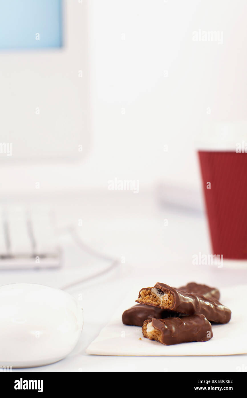 Chocolate bars on office desk Stock Photo - Alamy