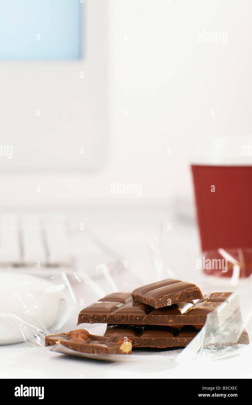 Pieces of chocolate on office desk Stock Photo - Alamy