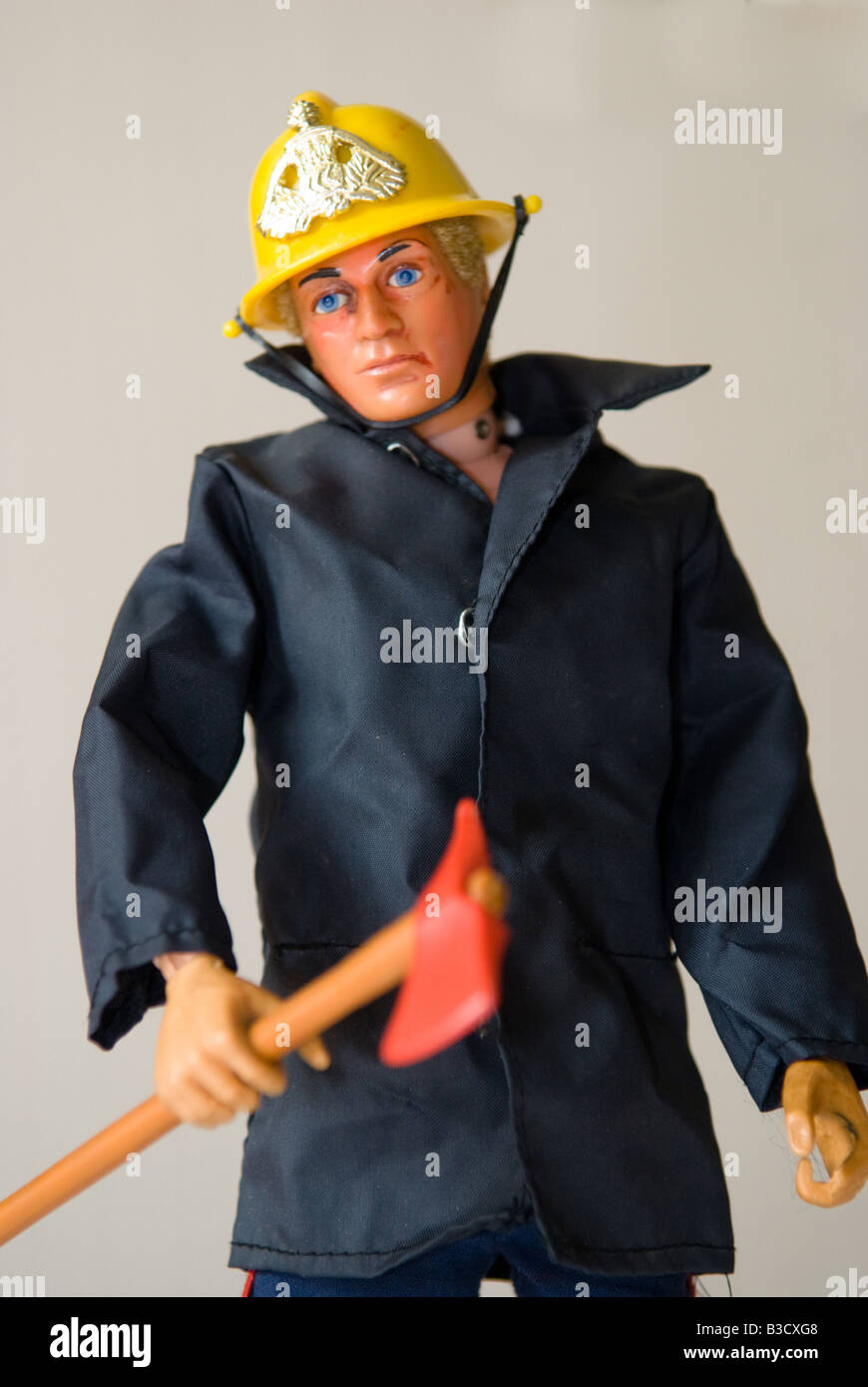 Action Figure dressed as Fireman holding long handled Axe Stock Photo ...