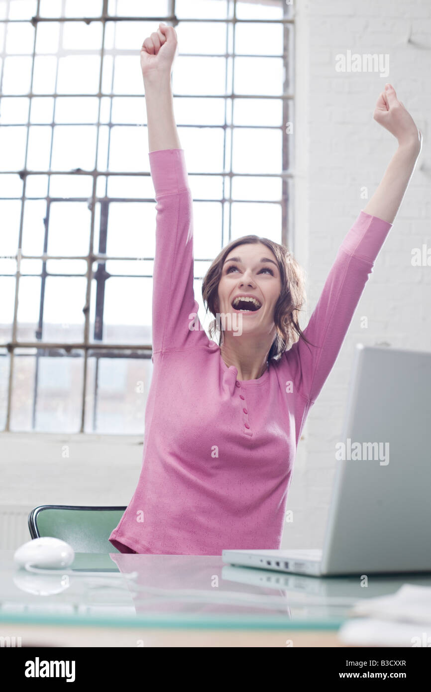 Young businesswoman in office, cheering Stock Photo - Alamy
