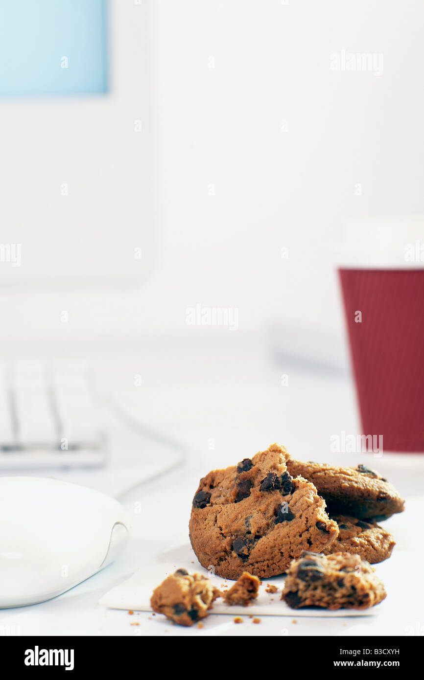 Cookies on desk alongside computer Stock Photo - Alamy