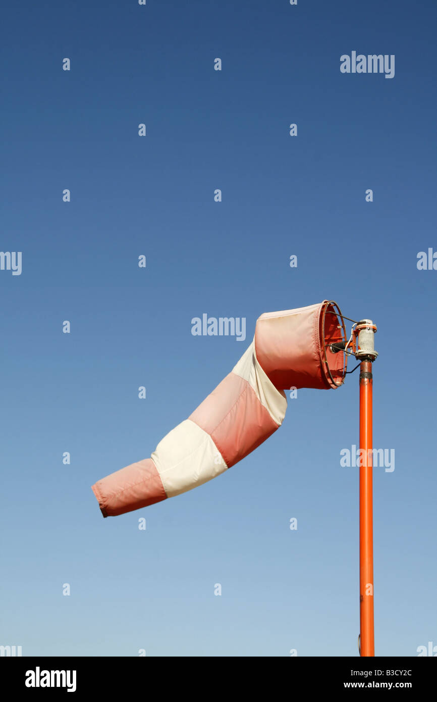 one wind sock blowing in wind at plane airport Stock Photo - Alamy