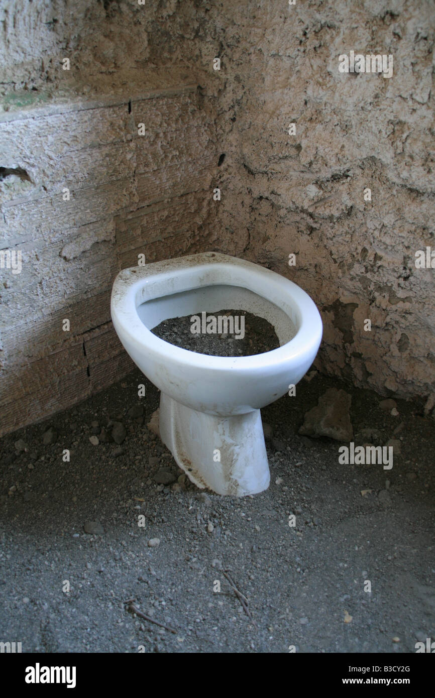 old damaged toilet pan inside derelict building Stock Photo - Alamy