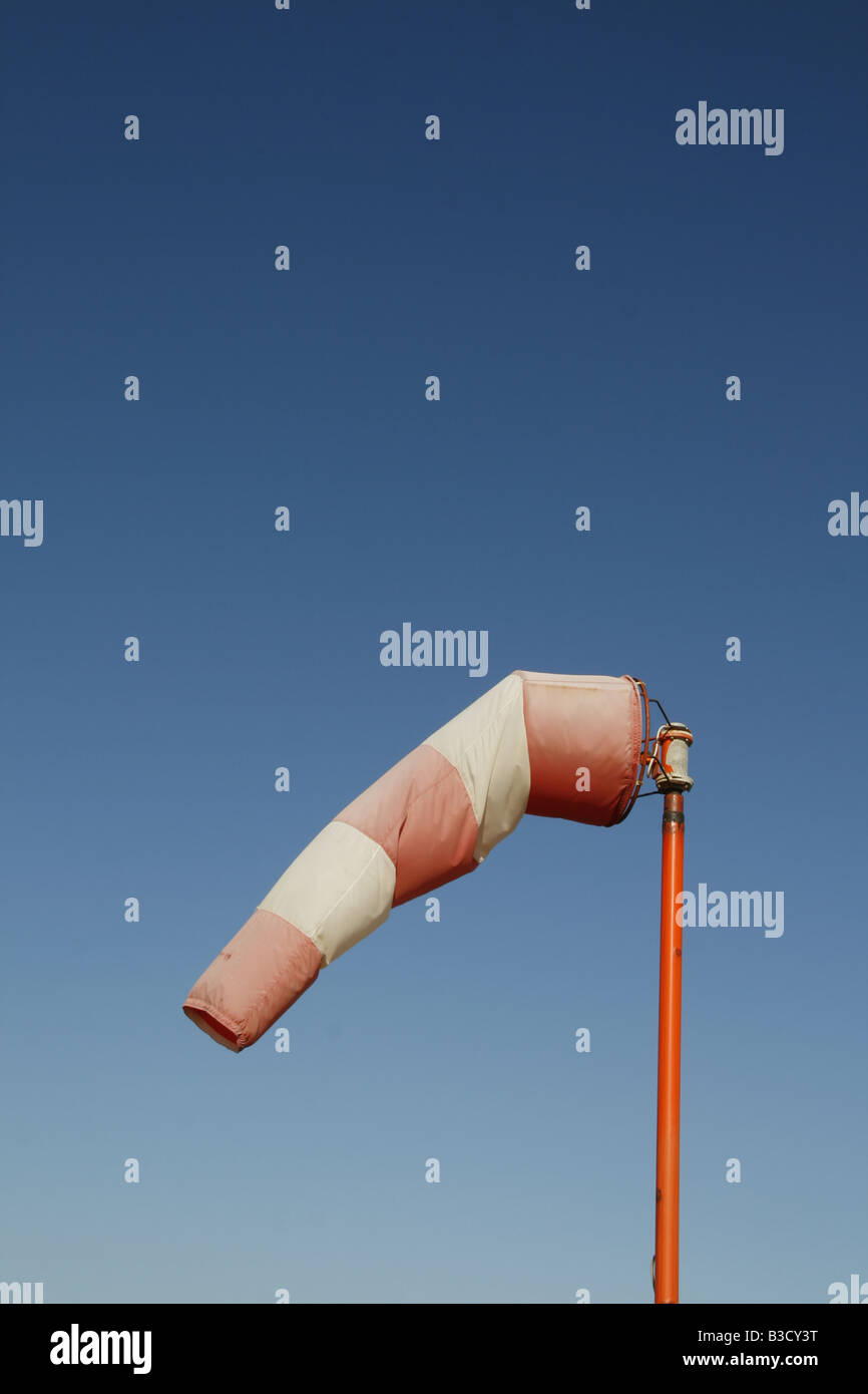 one wind sock blowing in wind at plane airport Stock Photo - Alamy