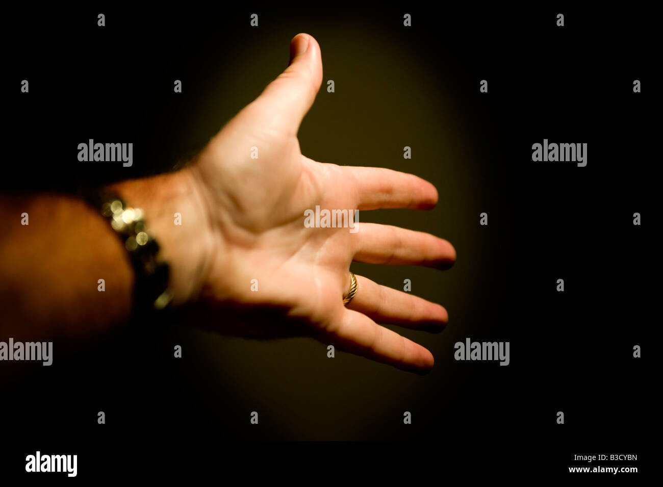A hand reaching out in the darkness Stock Photo - Alamy