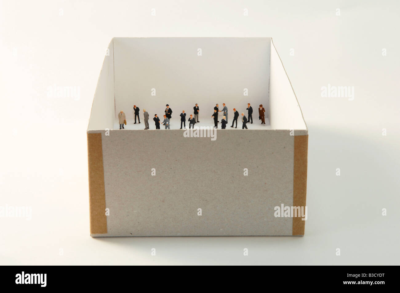 Business men figurines standing in cardboard box Stock Photo - Alamy
