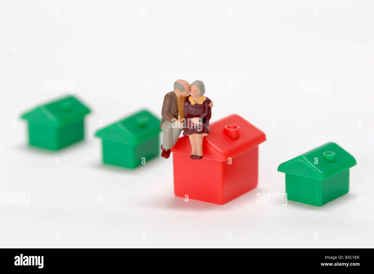 Plastic figurines sitting on roof of toy house Stock Photo - Alamy