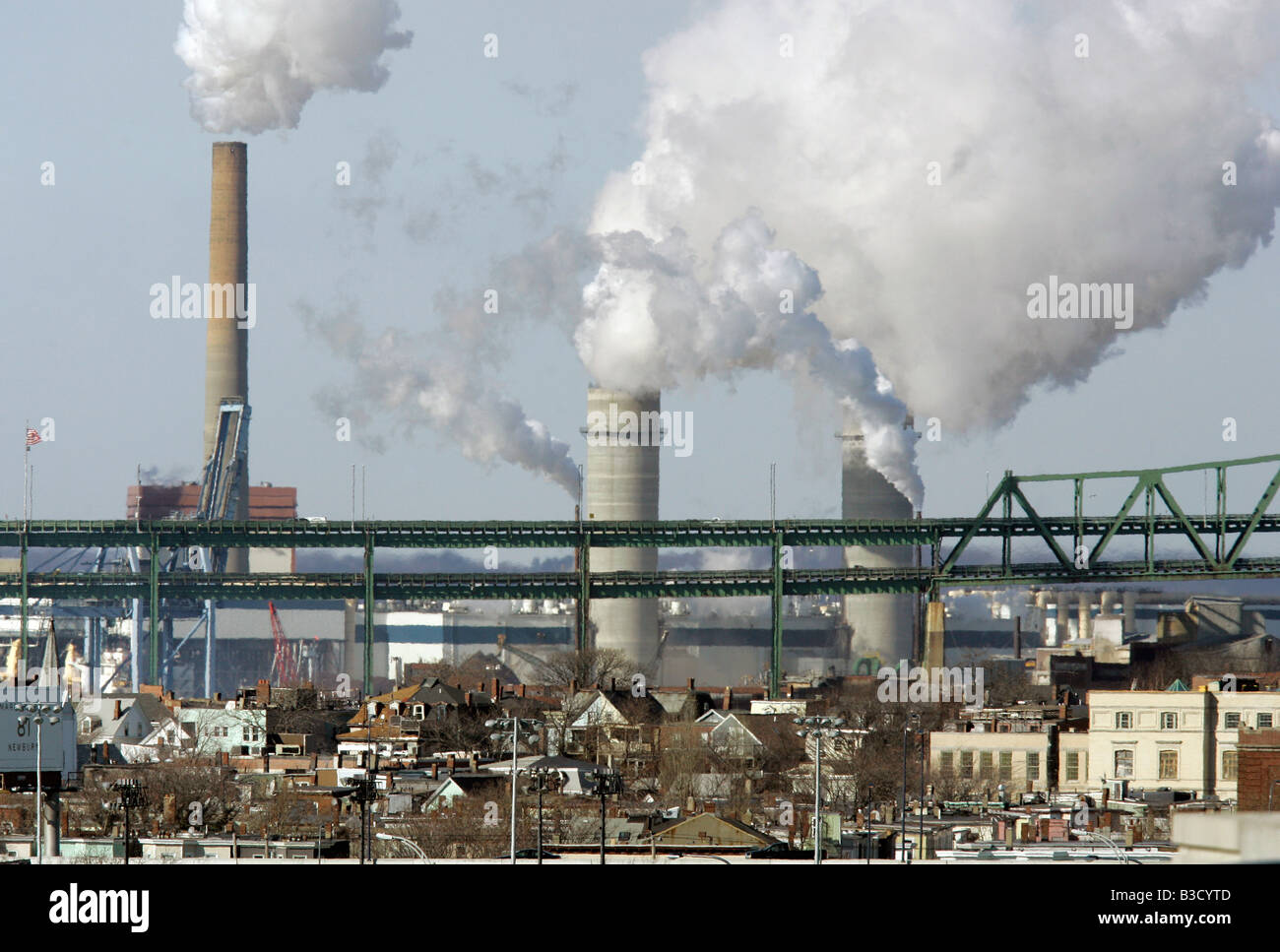 Steam billows from stacks over a residential neighborhood on a winter ...