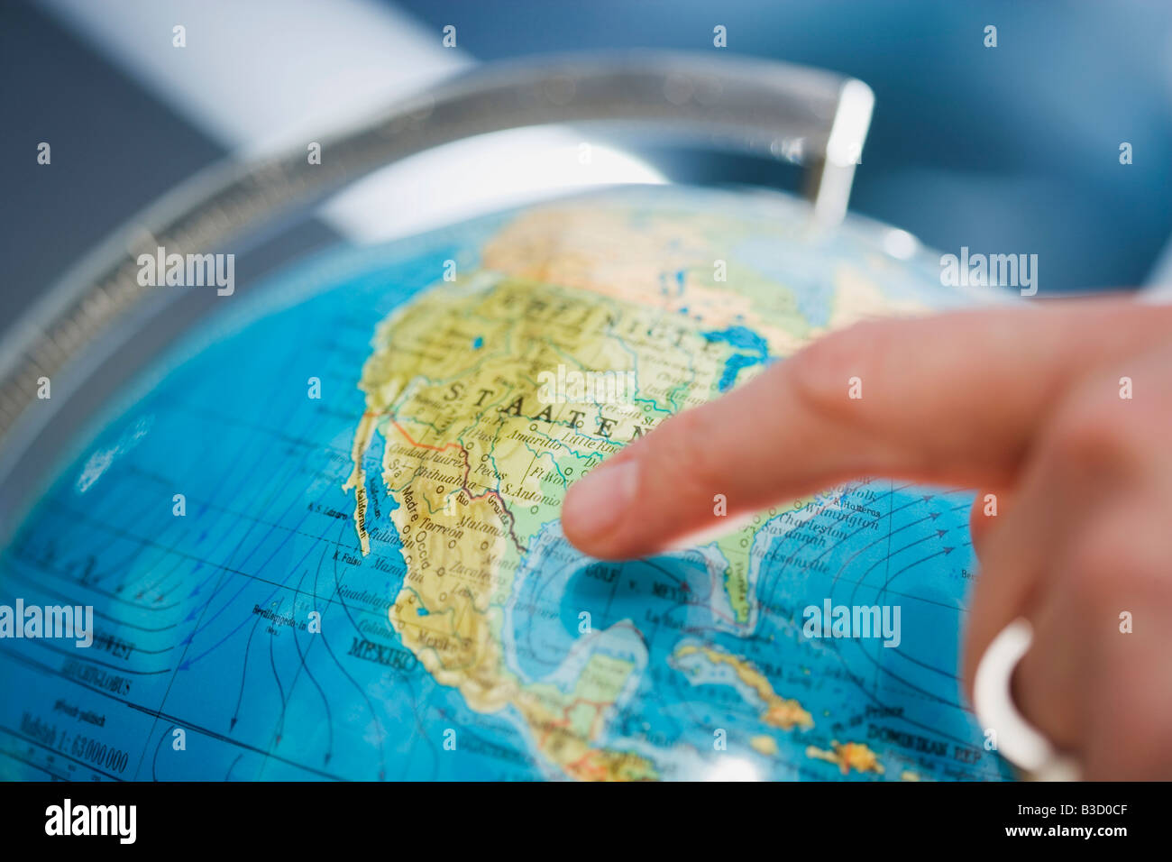 Person pointing at a globe Stock Photo - Alamy