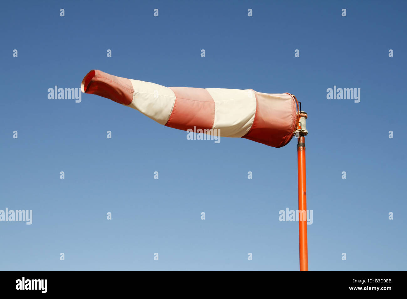 one wind sock blowing in wind at plane airport Stock Photo - Alamy