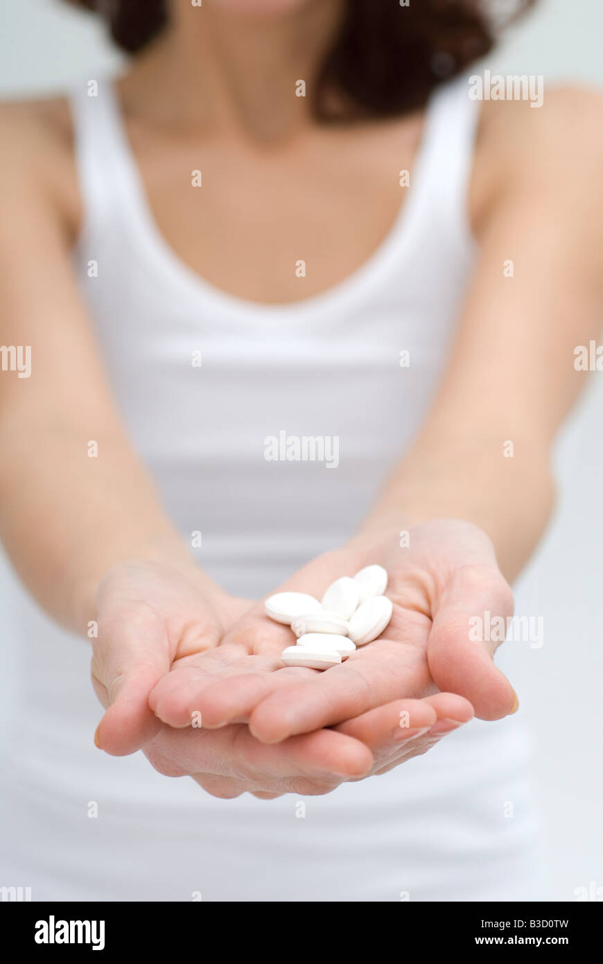 Woman holding tablets on hand, close up Stock Photo - Alamy