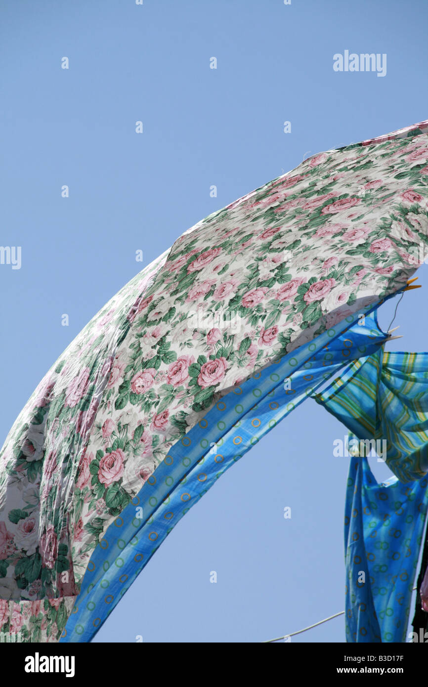 bedding flying in wind on washing line in sun Stock Photo - Alamy
