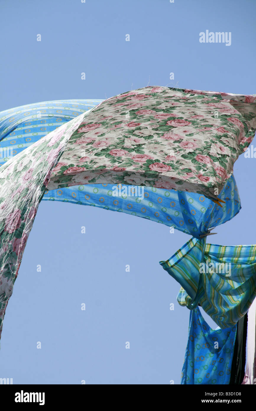 bedding flying in wind on washing line in sun Stock Photo - Alamy