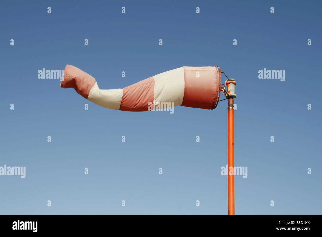 one wind sock blowing in wind at plane airport Stock Photo - Alamy